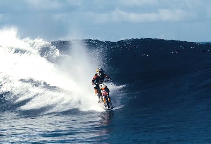 Watch This Daredevil Surfing Big Waves On a Dirt Bike