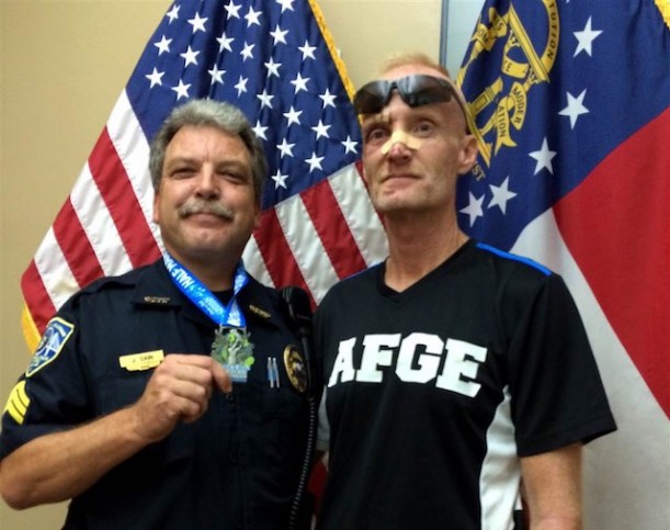 Both Winners: Police Officer Helps Injured Marathoner Get to Finish Line