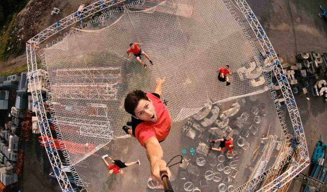 Daredevils Doing Flips on ‘World's Largest Trampoline’ Suspended From Crane Just Proves ...
