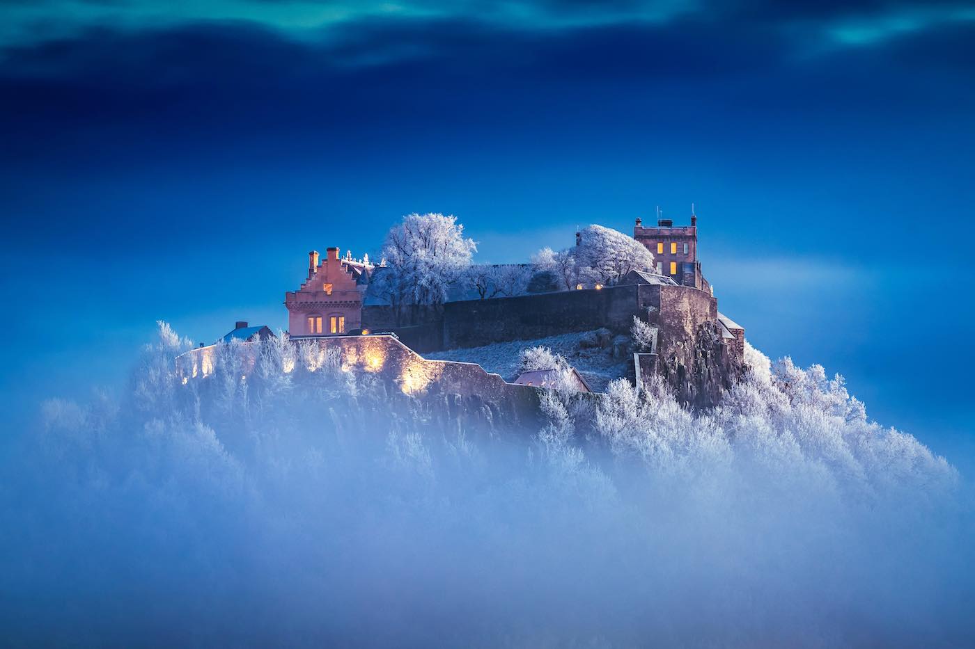 Photographer Snaps a Snow-capped Stirling Castle Shrouded in Mist at Sunset